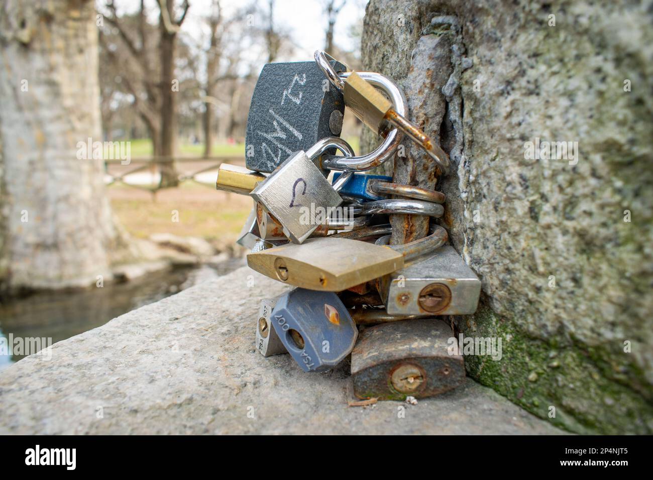 The locks on the concrete near the water and rocks Stock Photo - Alamy