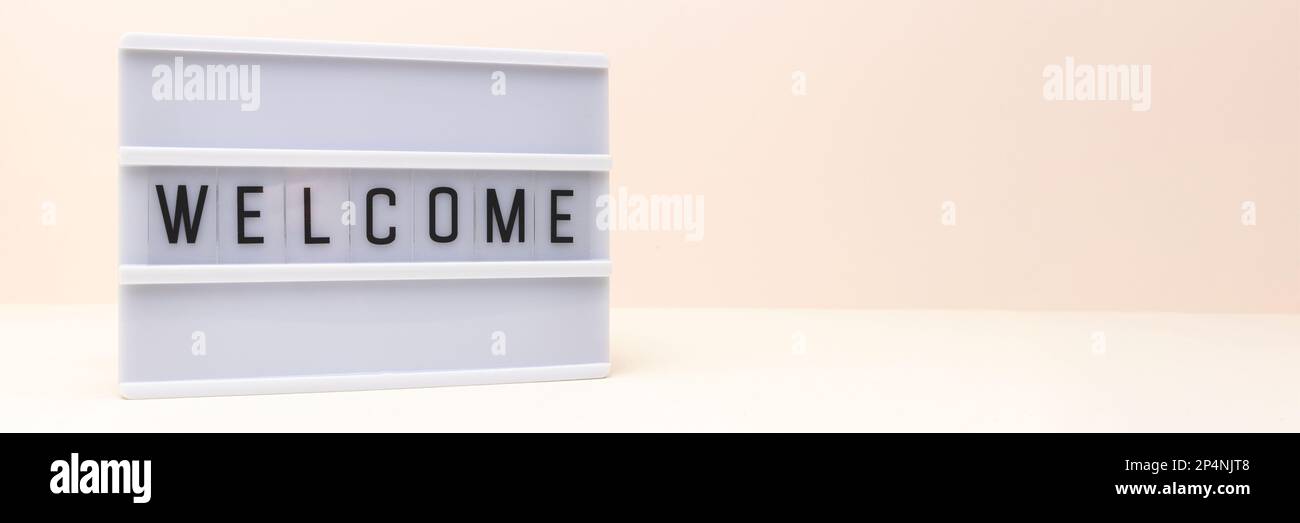 Banner with word Welcome. Lightbox with letters in front of beige ...