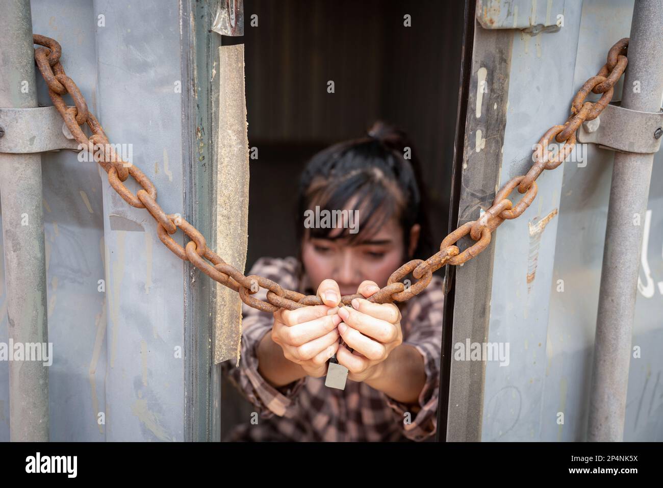 Woman trapped in cargo container wait for Human Trafficking or foreigh workers, Woman holding ...