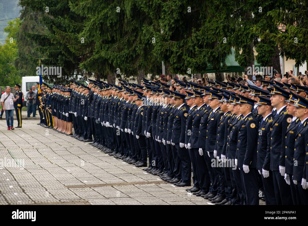 A line of soldiers standing in uniform next to some people Stock Photo ...