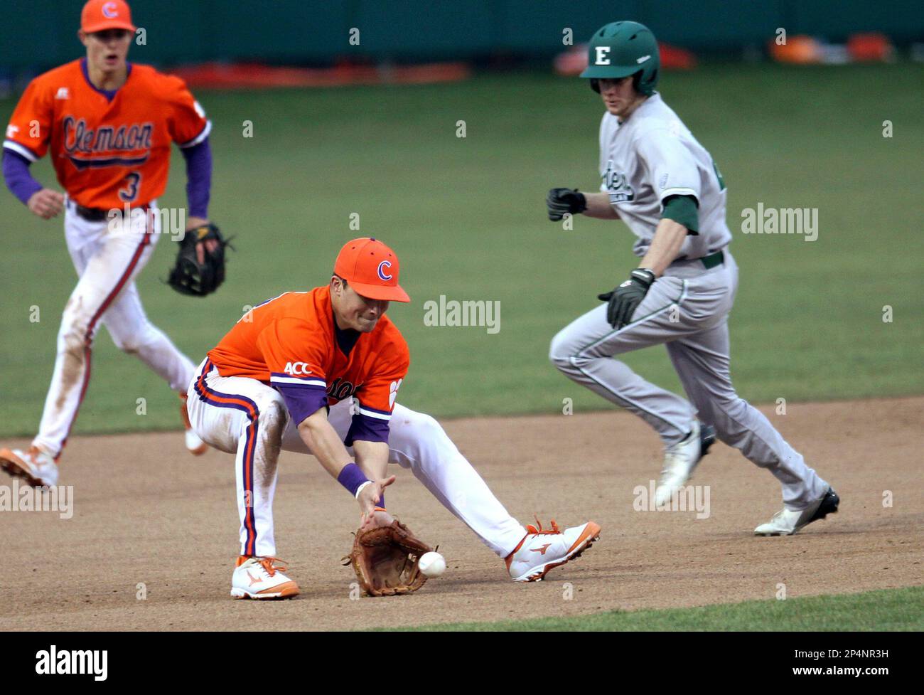 Clemson third baseman Jay Baum, center, fields a ground ball as Eastern ...