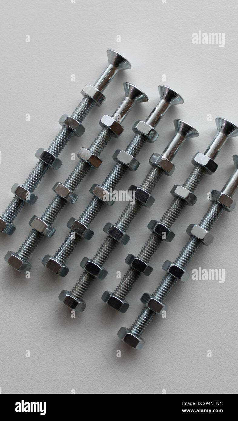 Nuts On A Long Screw Bolts On White Surface Top View Textured ...