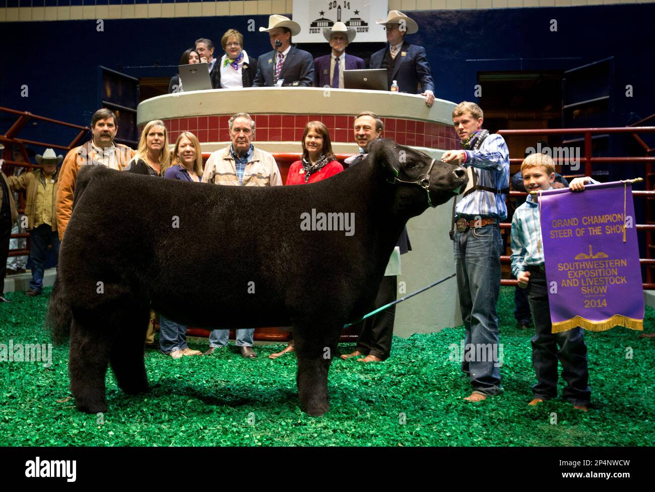 Flint Newman poses with his grand champion steer and the buyers Larry ...