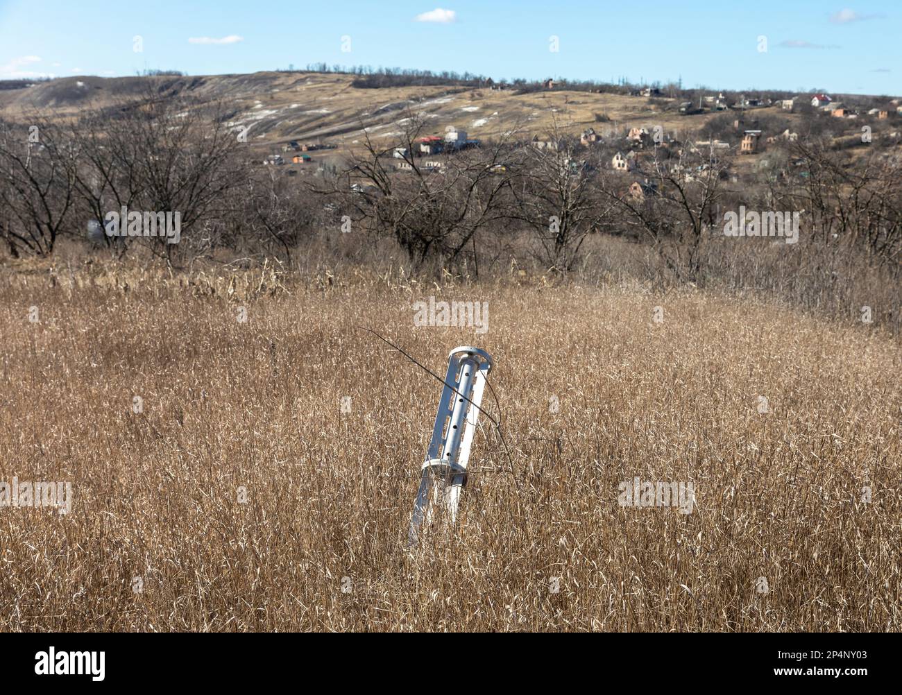 Wartime signs. Unexploded shell seen in the middle of a field. Remains ...