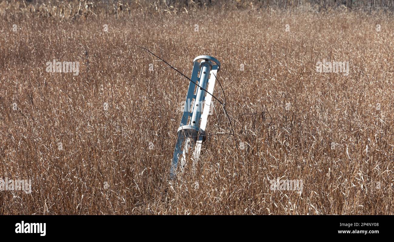 Wartime signs. Unexploded shell seen in the middle of a field. Remains ...