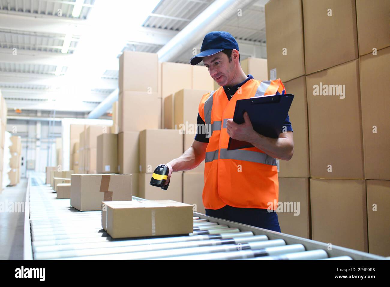 workers in a goods warehouse - storage and transport of goods by mail ...