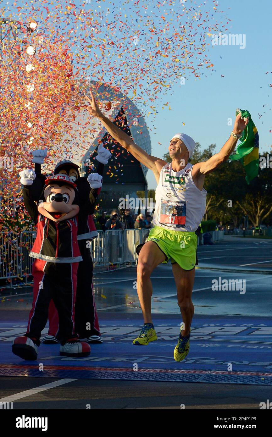 Fredison Costa, right, of Brazil, crosses the finish line to win the ...
