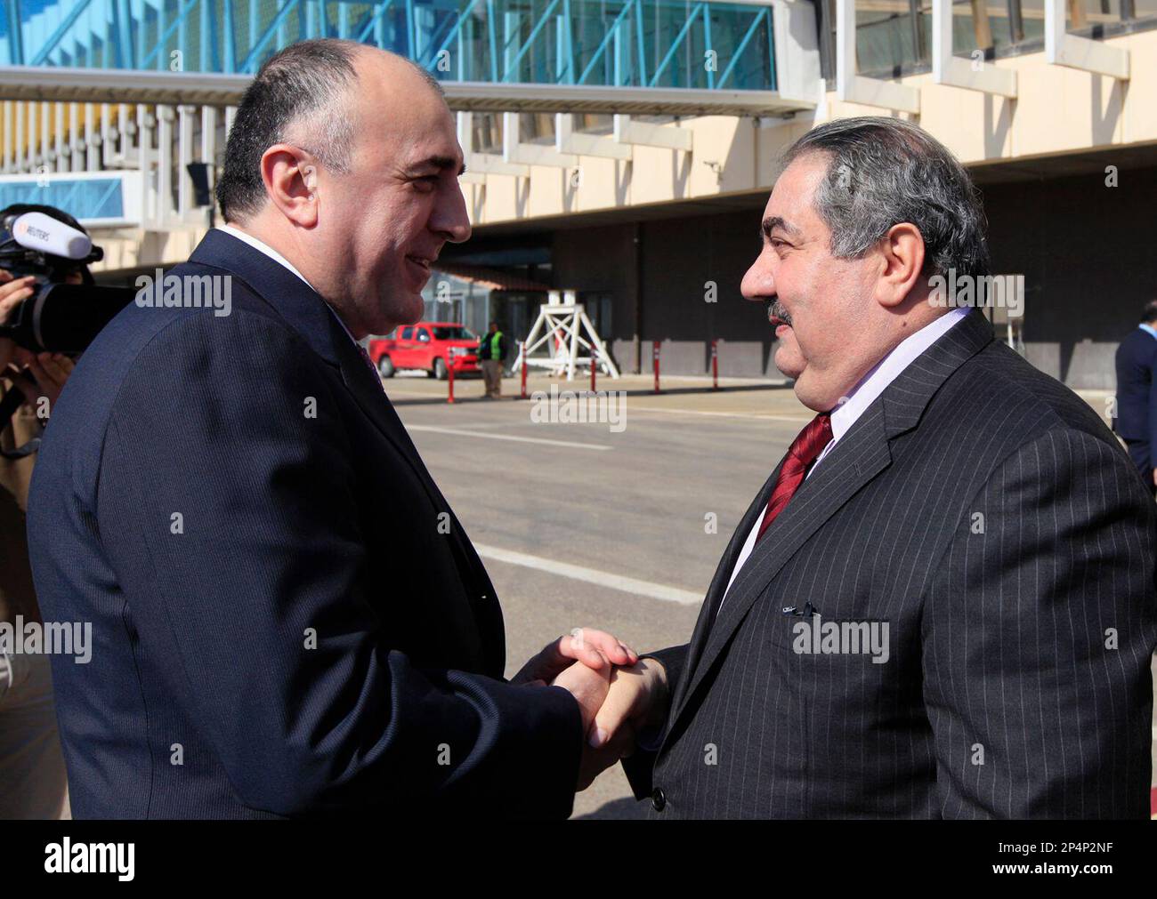 Iraqi Foreign Minister Hoshyar Zebari, right, shakes hands with his ...