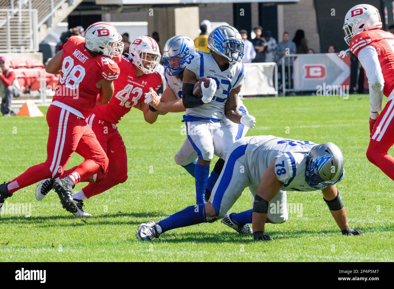Brian Hill, Battlehawks’ running back, squeezes his way between two ...