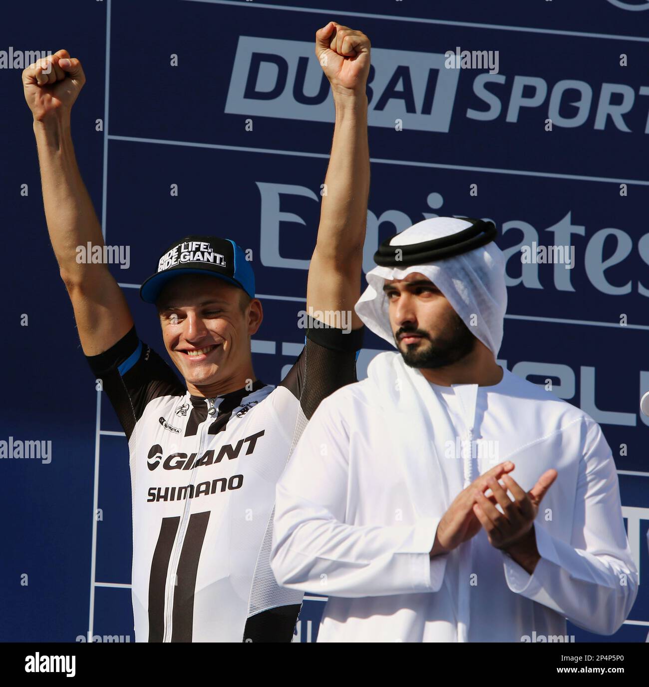 German cyclist Marcel Kittel of Team Giant-Shimano, left, raises his ...