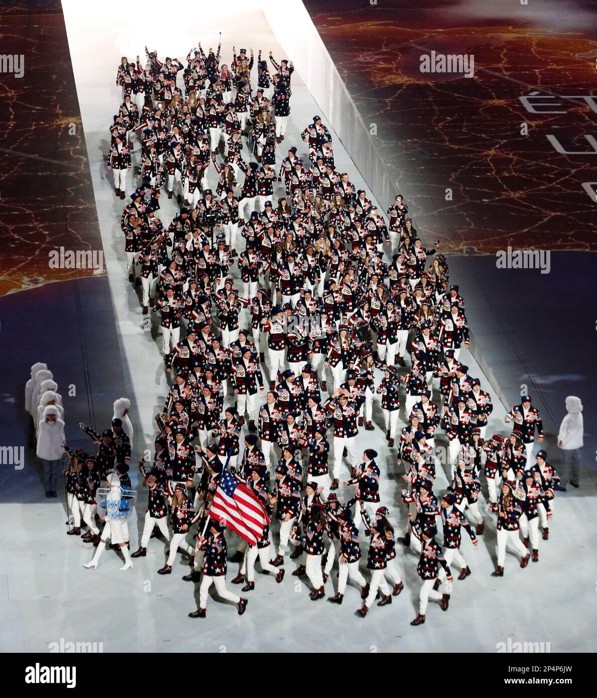 Todd Lodwick of the United States carries the national flag as he leads ...