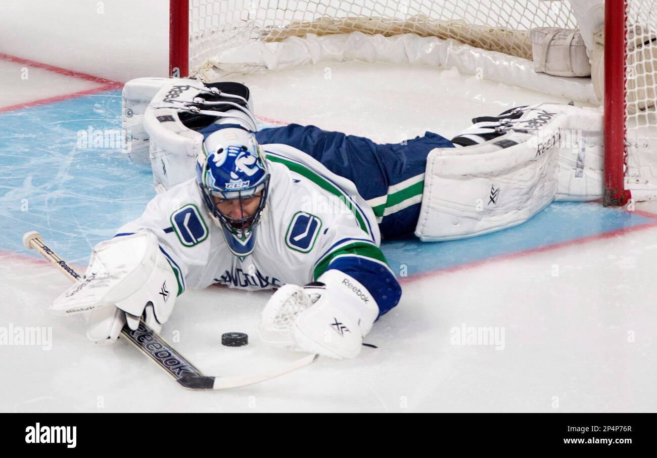Vancouver Canucks goaltender Roberto Luongo makes a save against the ...
