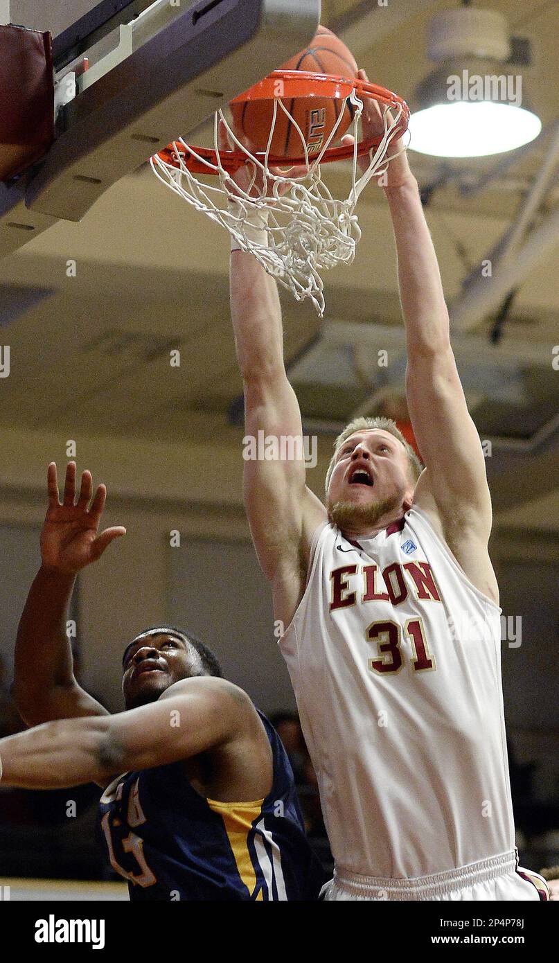 Elon forward Lucas Troutman dunks the ball over UNC Greensboro forward ...