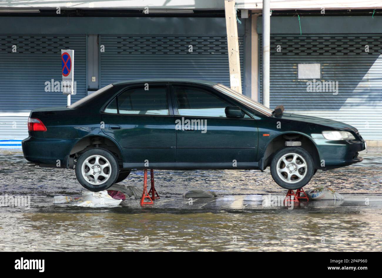 Bangkok, Thailand - November 07, 2011: Raised car under a highway ...