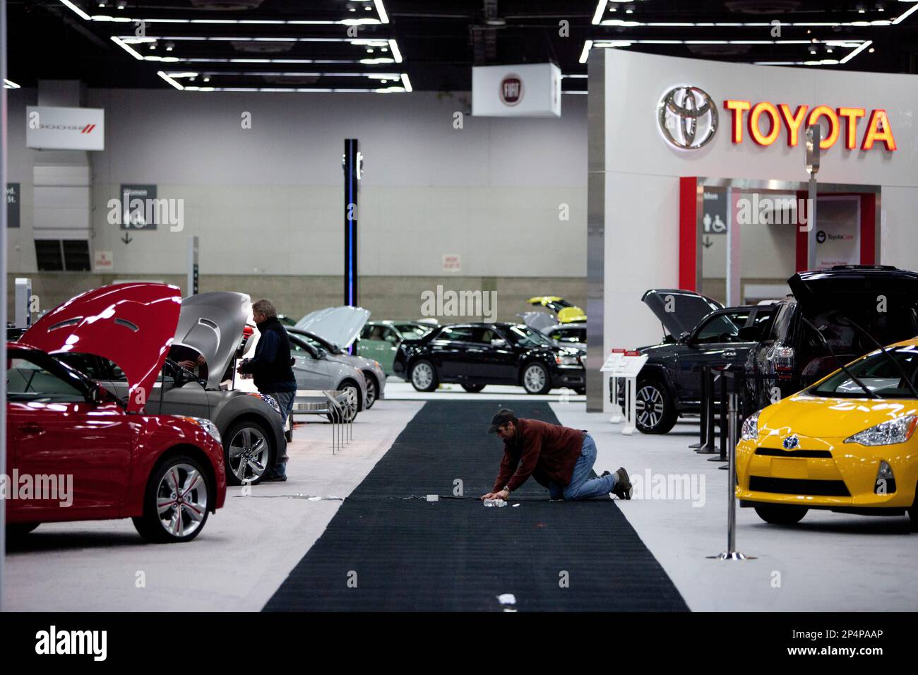 A worker adjusts the carpet during a sneak peek inside the 2014 ...