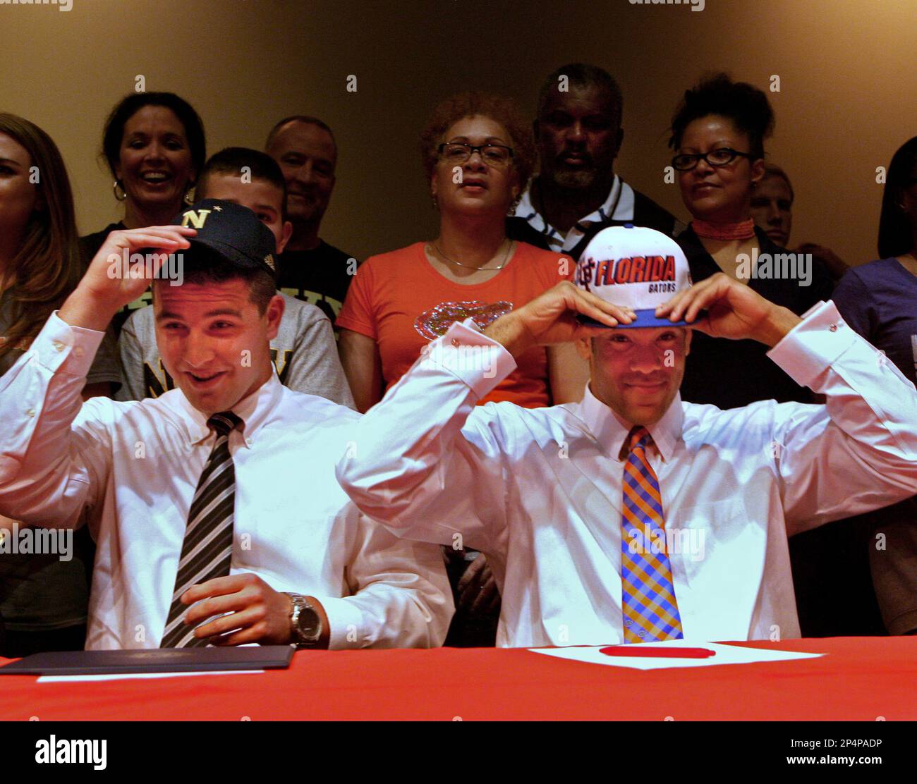 Conner Dorris (Navy) and Justus Reed (Florida) try on their hats after ...