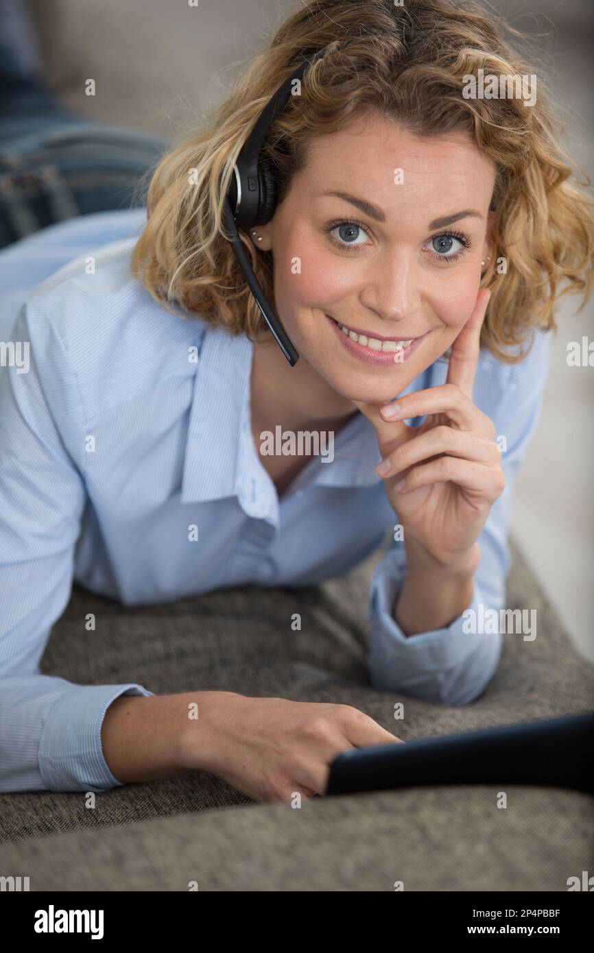 blond woman relaxing in sofa calling with headset Stock Photo - Alamy