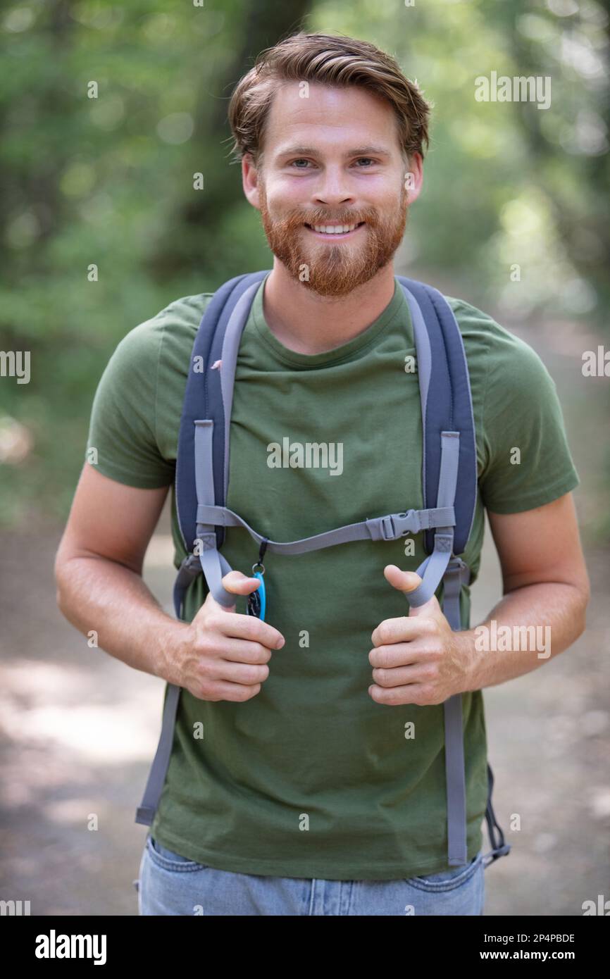 portrait of man wearing backpack in a rural setting Stock Photo - Alamy