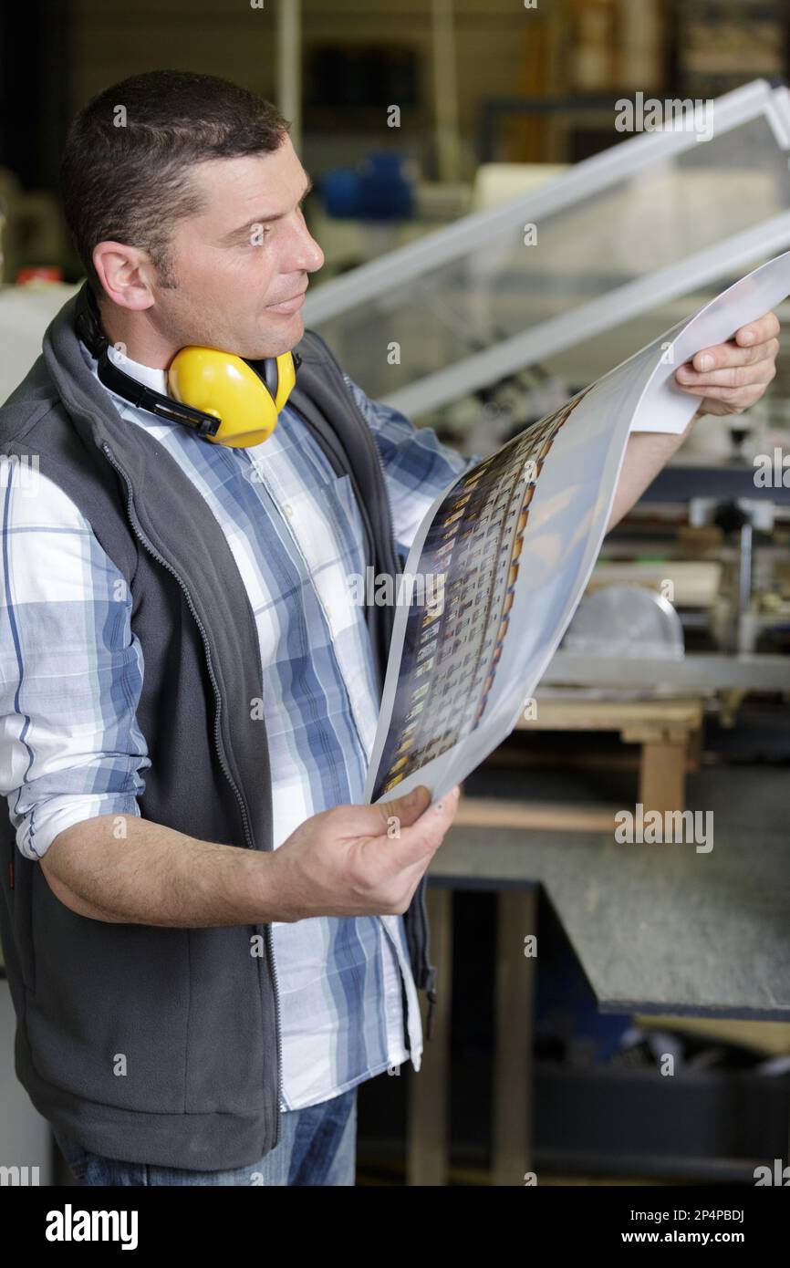 operative checking printing quality in printing factory Stock Photo - Alamy