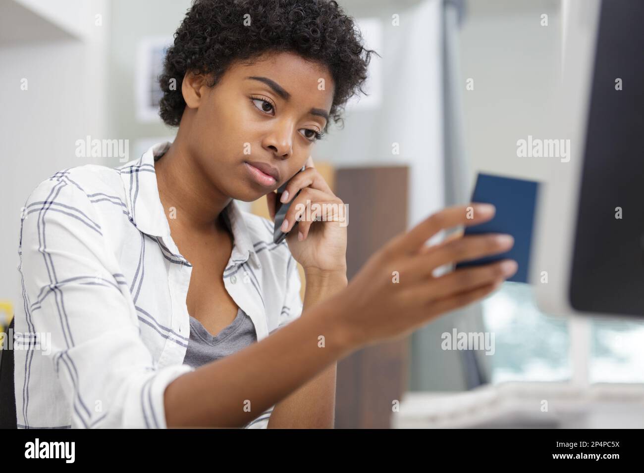 interior designer holding colour swatch and talking on telephone Stock ...