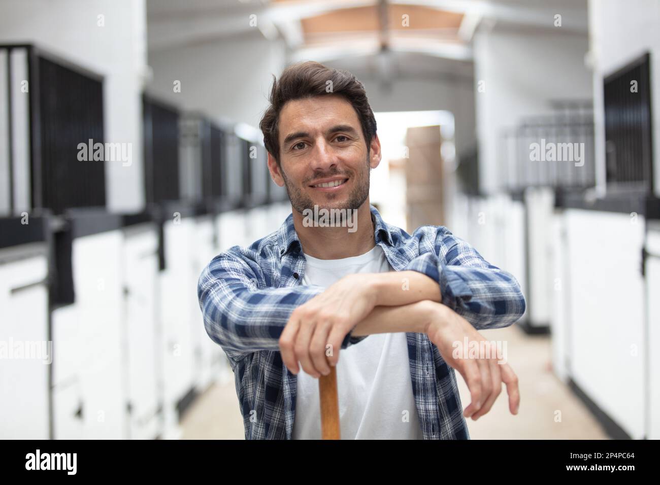 good looking worker posing in stable Stock Photo - Alamy