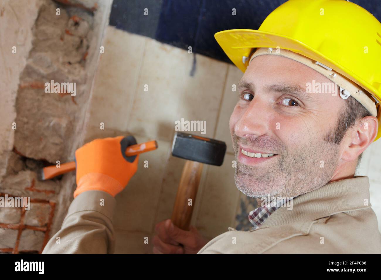 happy builder with a hammer Stock Photo - Alamy