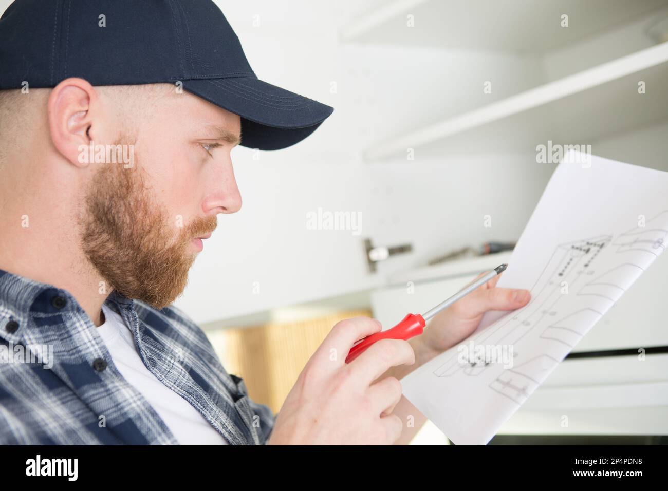male worker reading a manual Stock Photo - Alamy