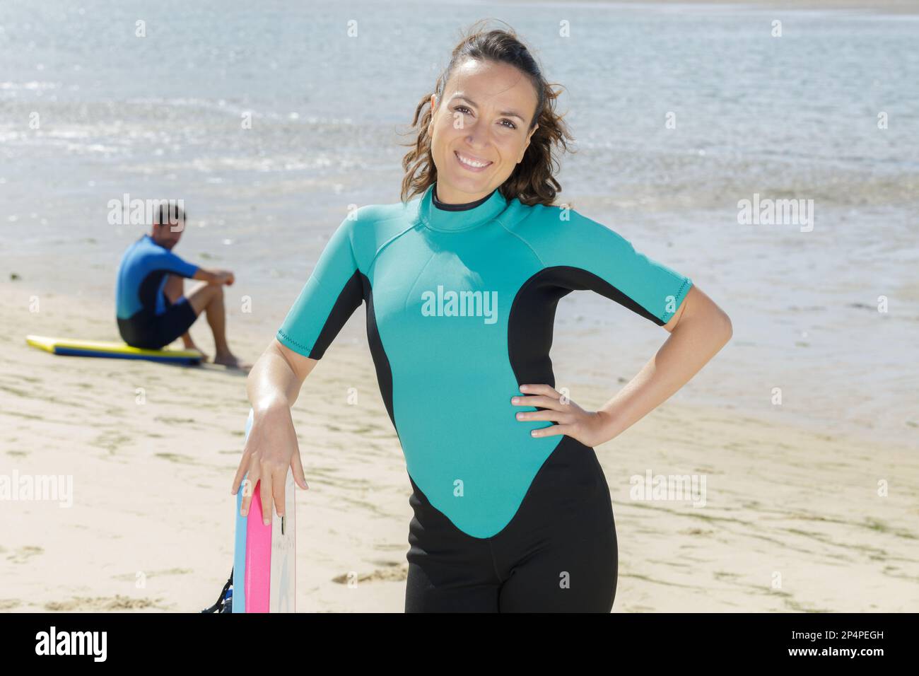 female surfer posing with surfboard Stock Photo - Alamy