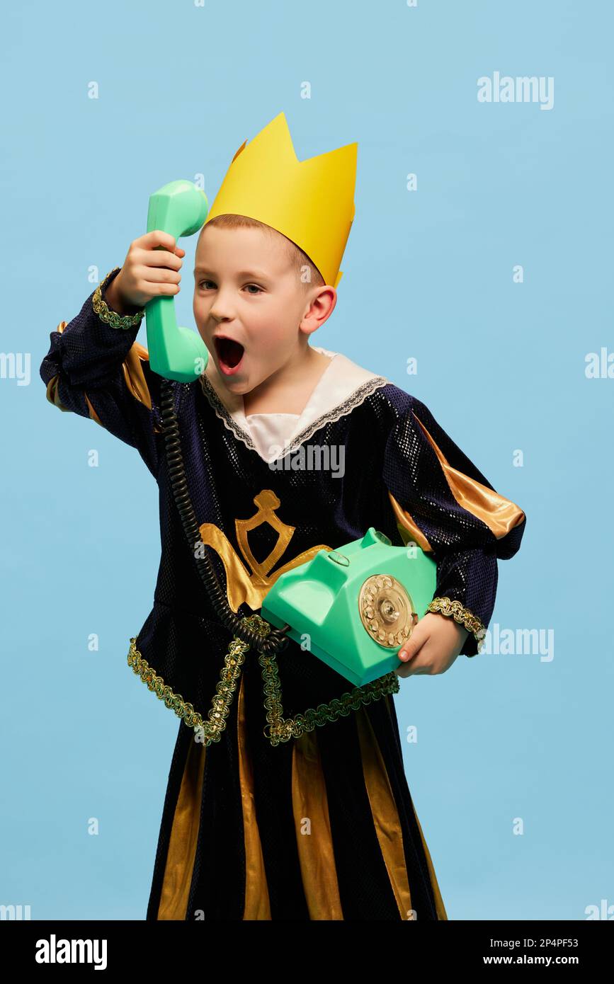 Joyful little cute boy in costume of medieval little prince in paper ...