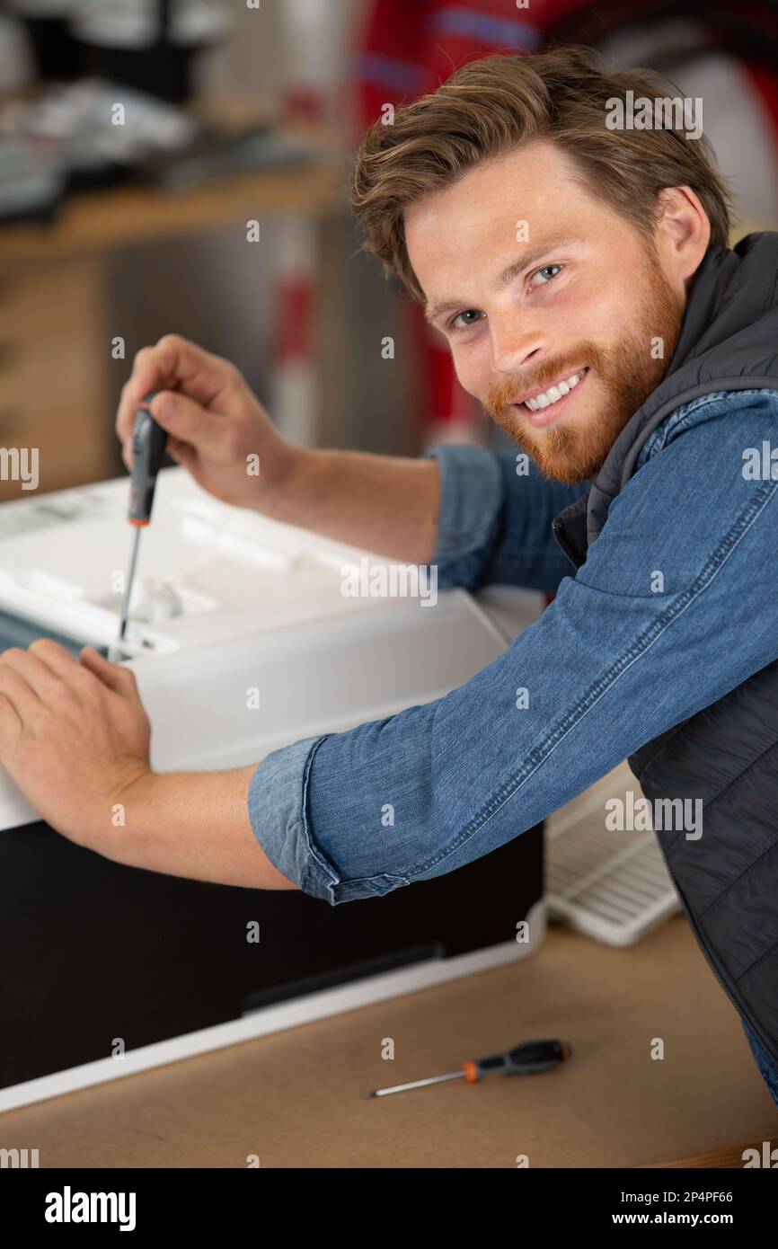 happy man during repair of wi-fi router Stock Photo - Alamy
