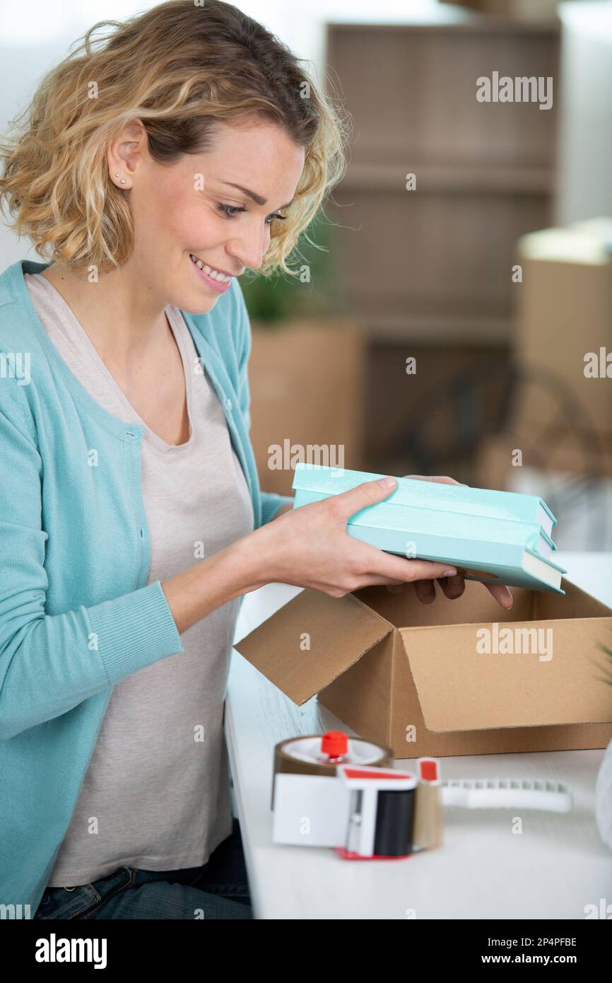 Girl packing books hi-res stock photography and images - Alamy