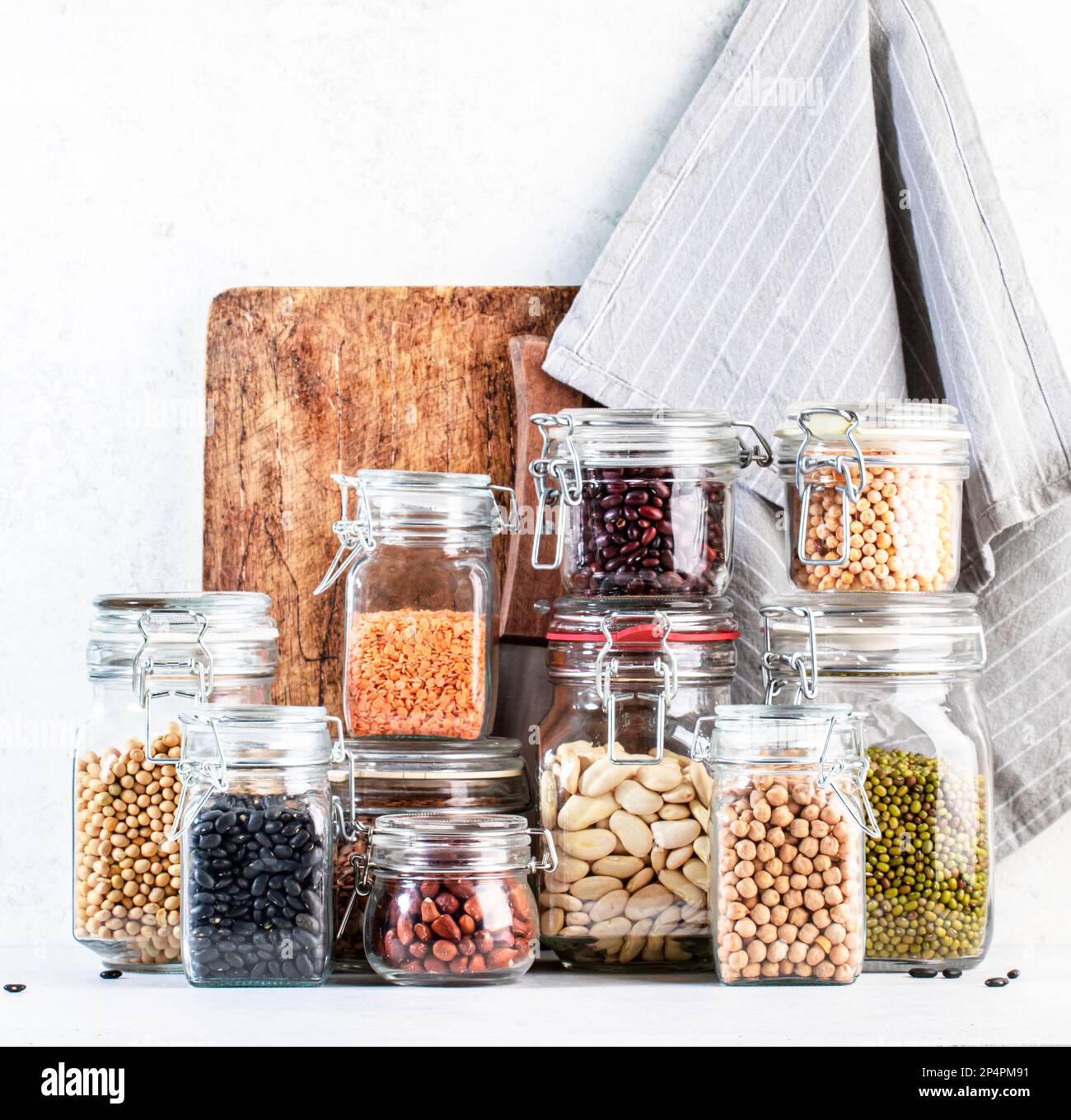 Legumes and beans set in jars. Dried raw lentils, chickpeas, mung beans ...