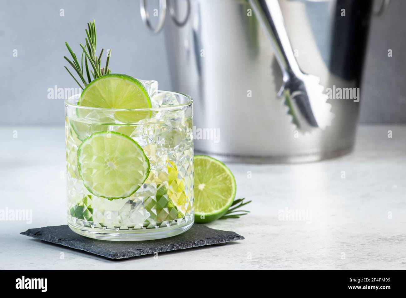Gin tonic classic cocktail drink with dry gin, bitter tonic, lime and ...