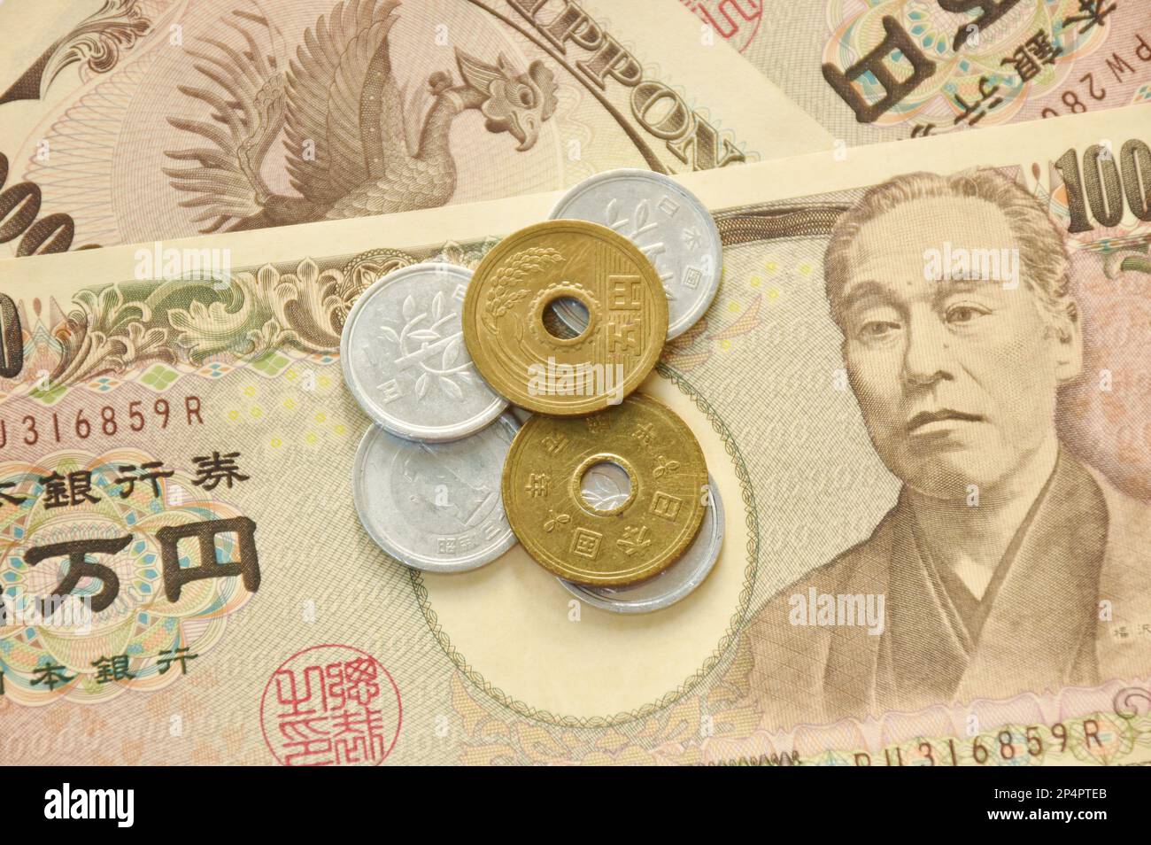 Japanese yen banknote and coin on white background Stock Photo - Alamy