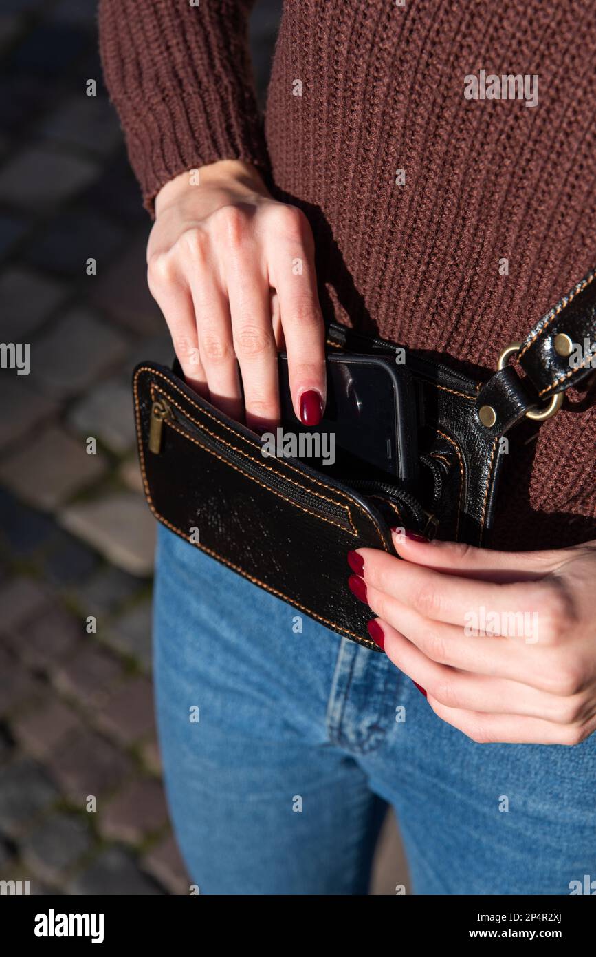 Girl is looking for something in a belt bag. unisex leather hip ...