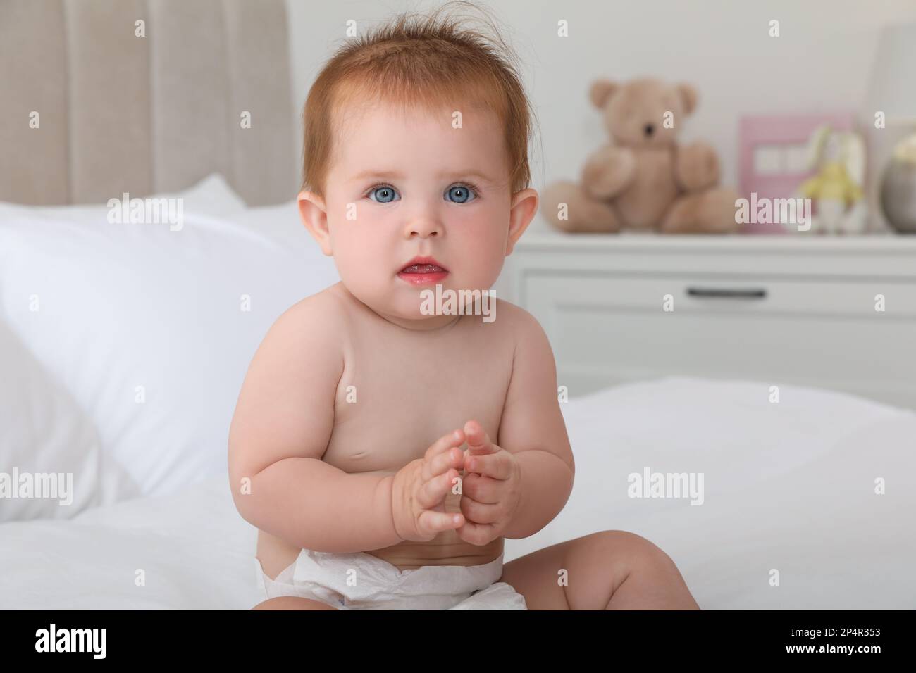 Cute little redhead baby on bed at home Stock Photo - Alamy