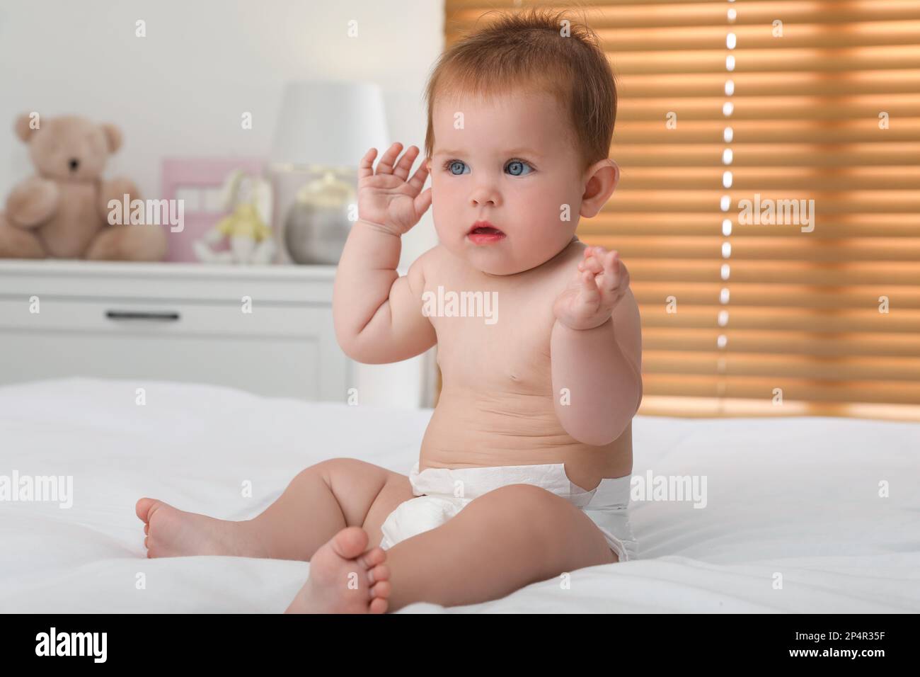 Cute little redhead baby on bed at home Stock Photo - Alamy