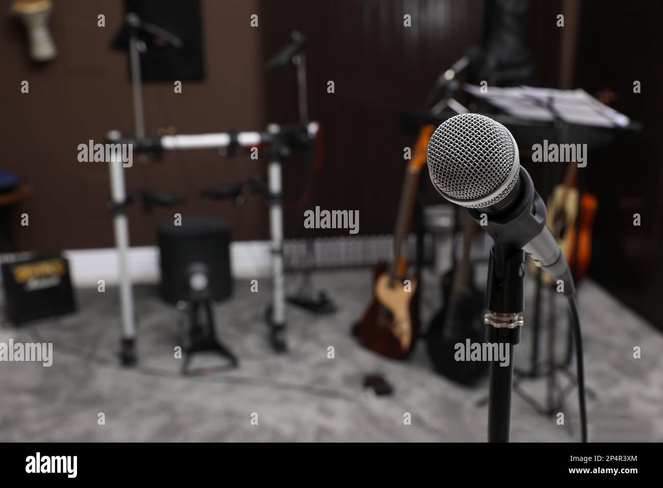 Modern microphone at recording studio, space for text. Music band ...