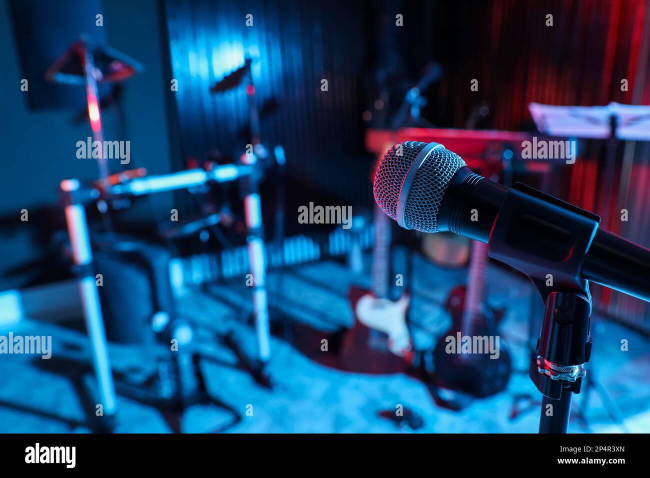 Modern microphone at recording studio, color toned. Music band practice ...