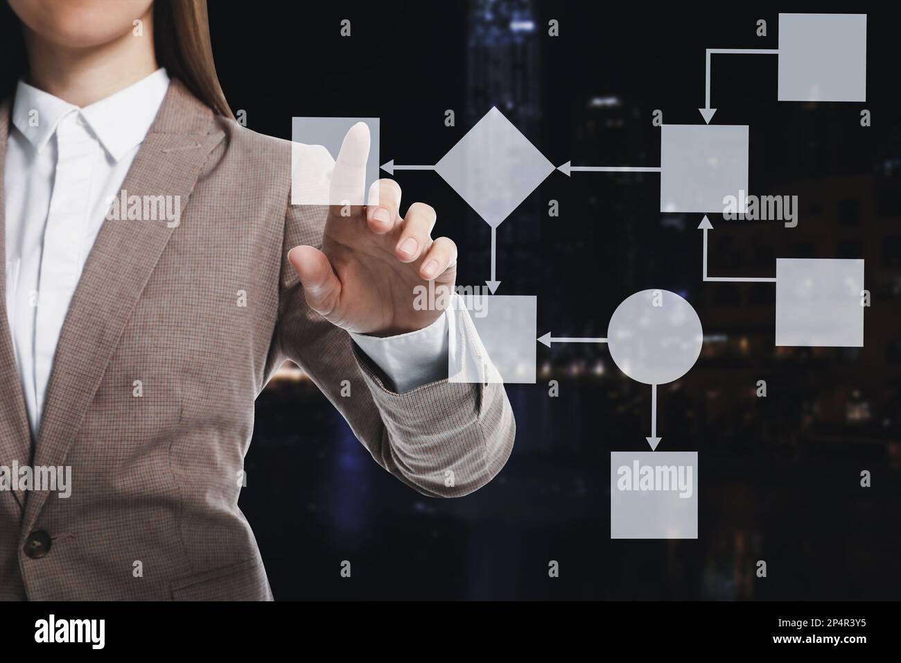 Woman pointing at flowchart on virtual screen against blurred ...