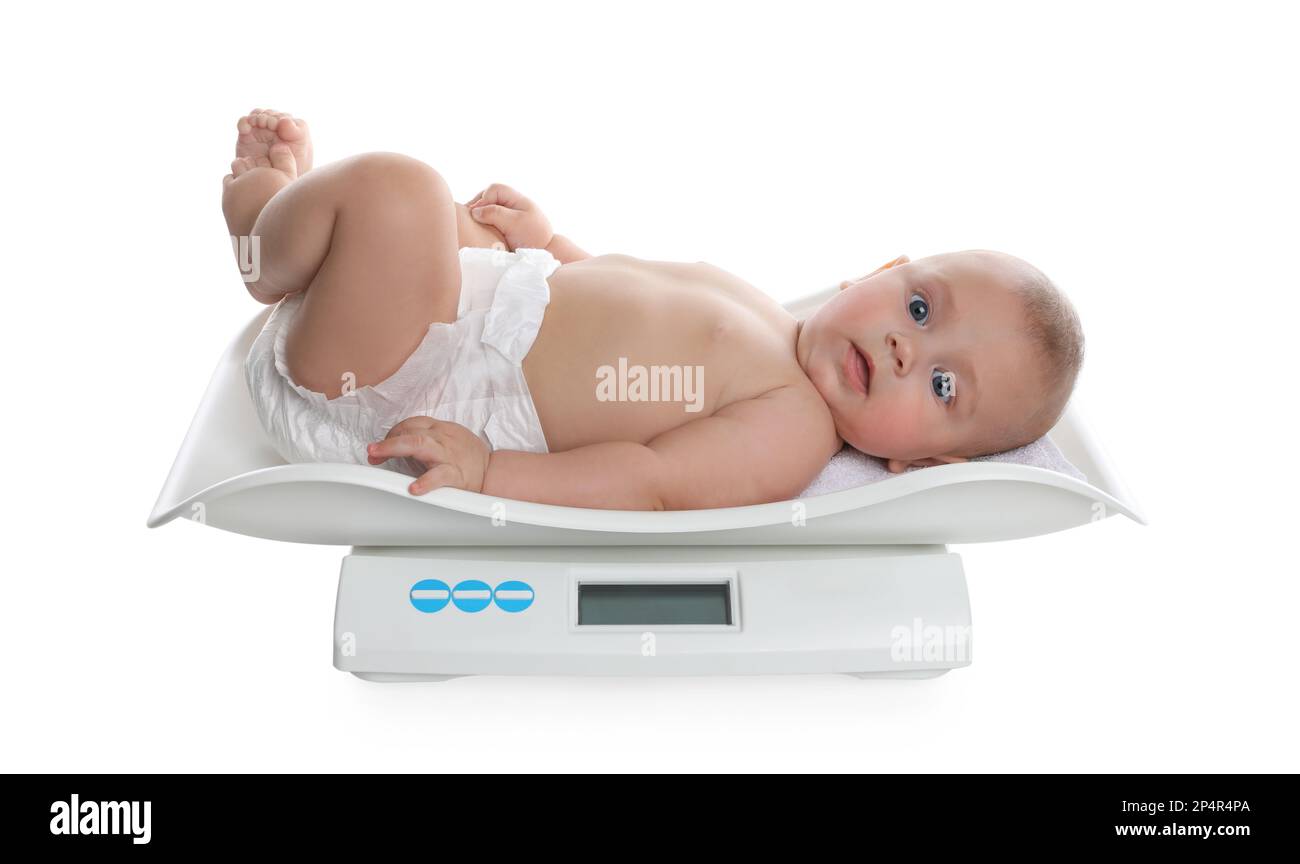 Cute little baby lying on scales against white background Stock Photo ...