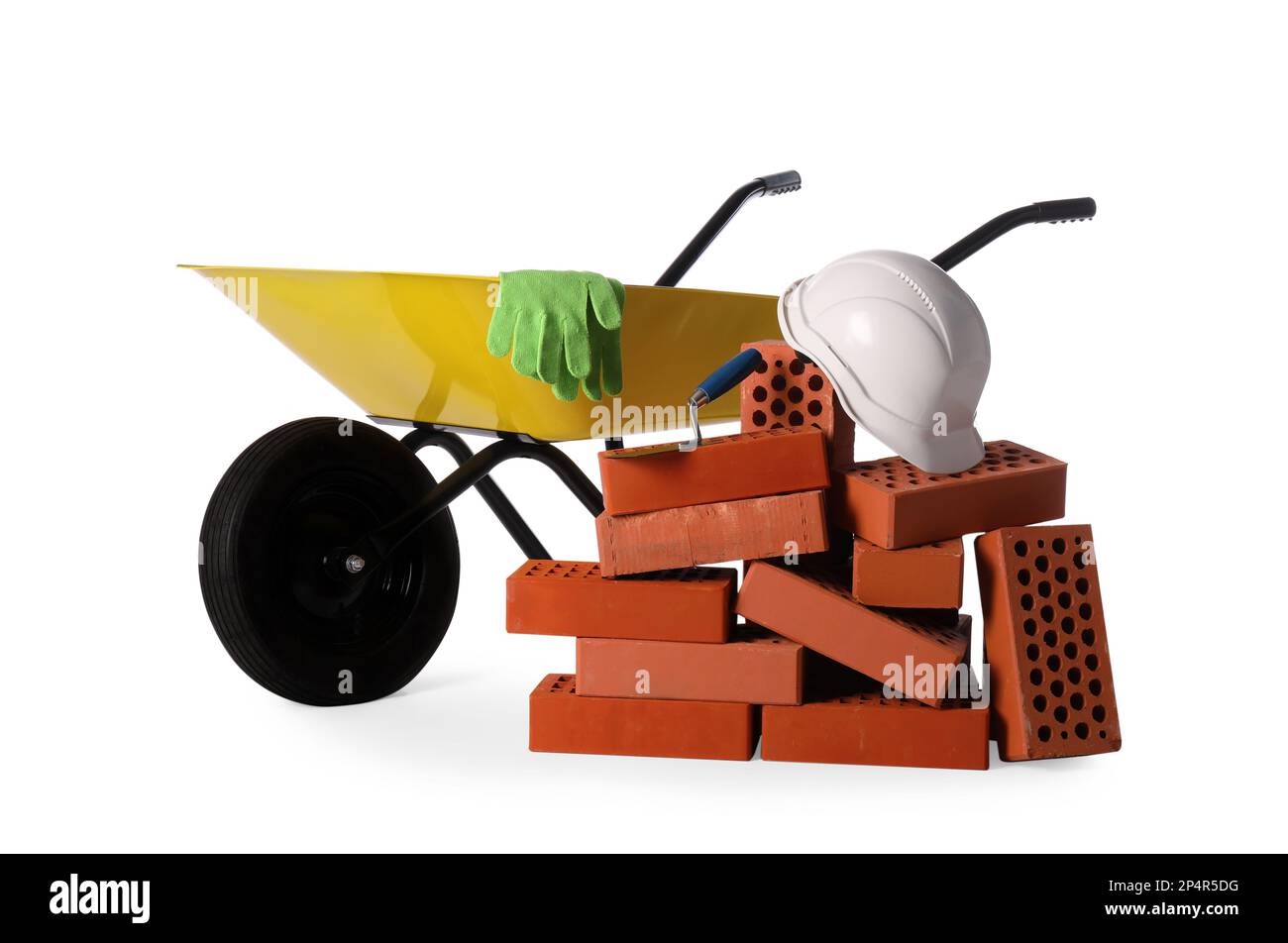 Many red bricks, wheelbarrow and construction tools on white background ...