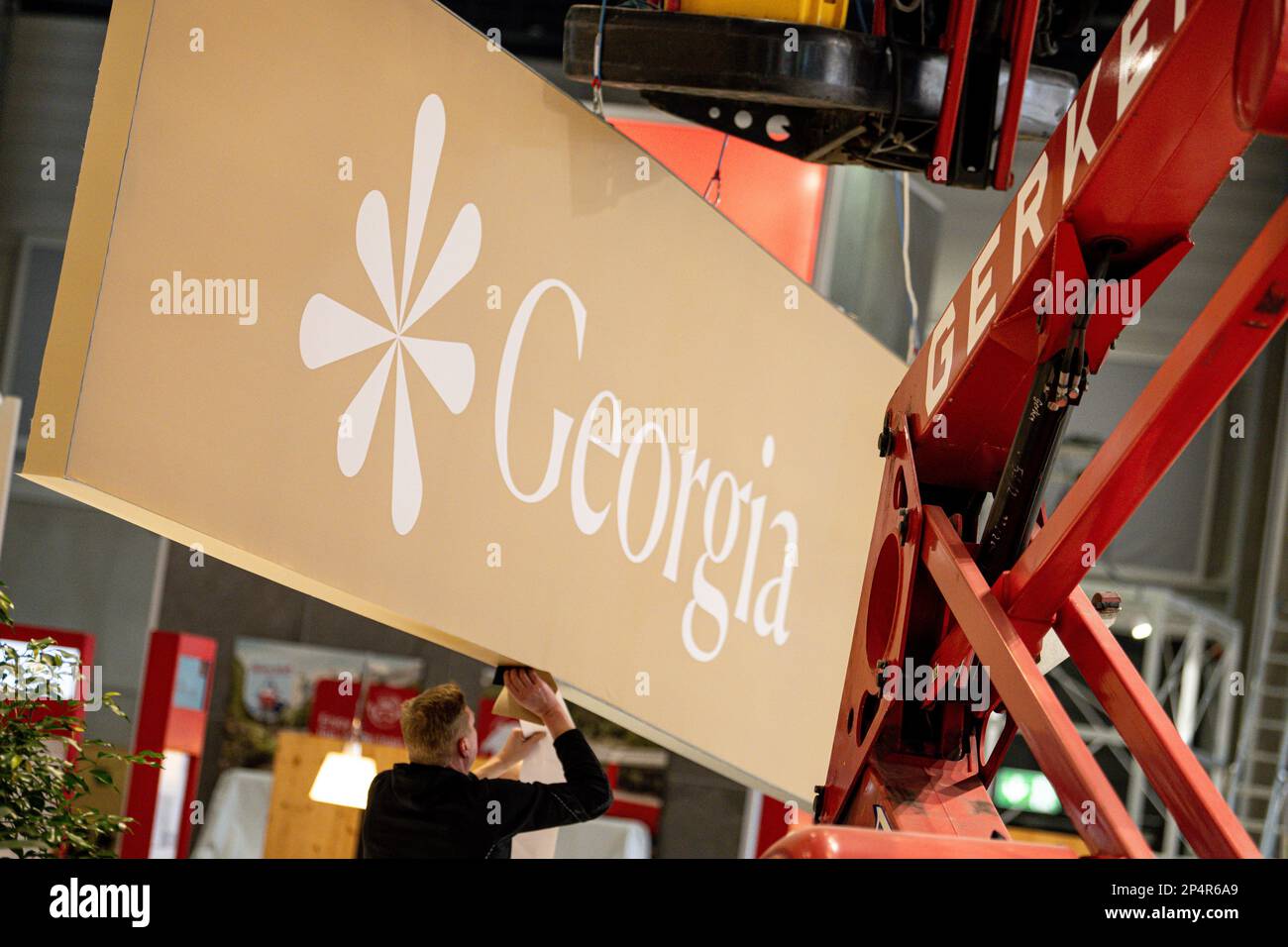 06 March 2023, Berlin: People work at the stand for Georgia before the ...