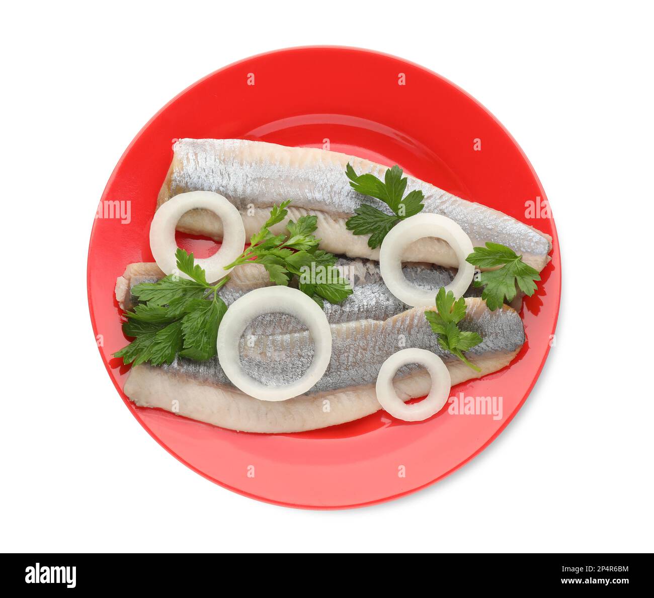 Red plate with delicious salted herring fillets, onion rings and ...