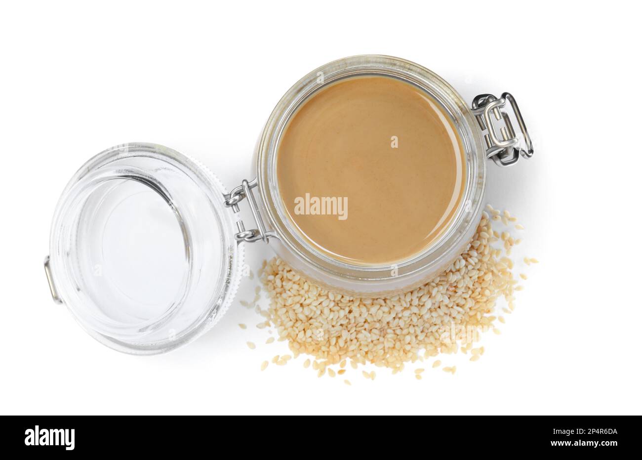 Tasty sesame paste in jar and seeds on white background, top view Stock ...