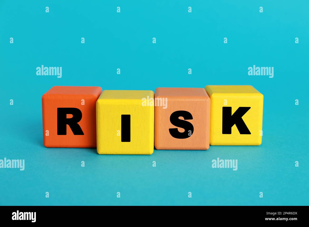 Word Risk made of colorful cubes on turquoise background Stock Photo ...