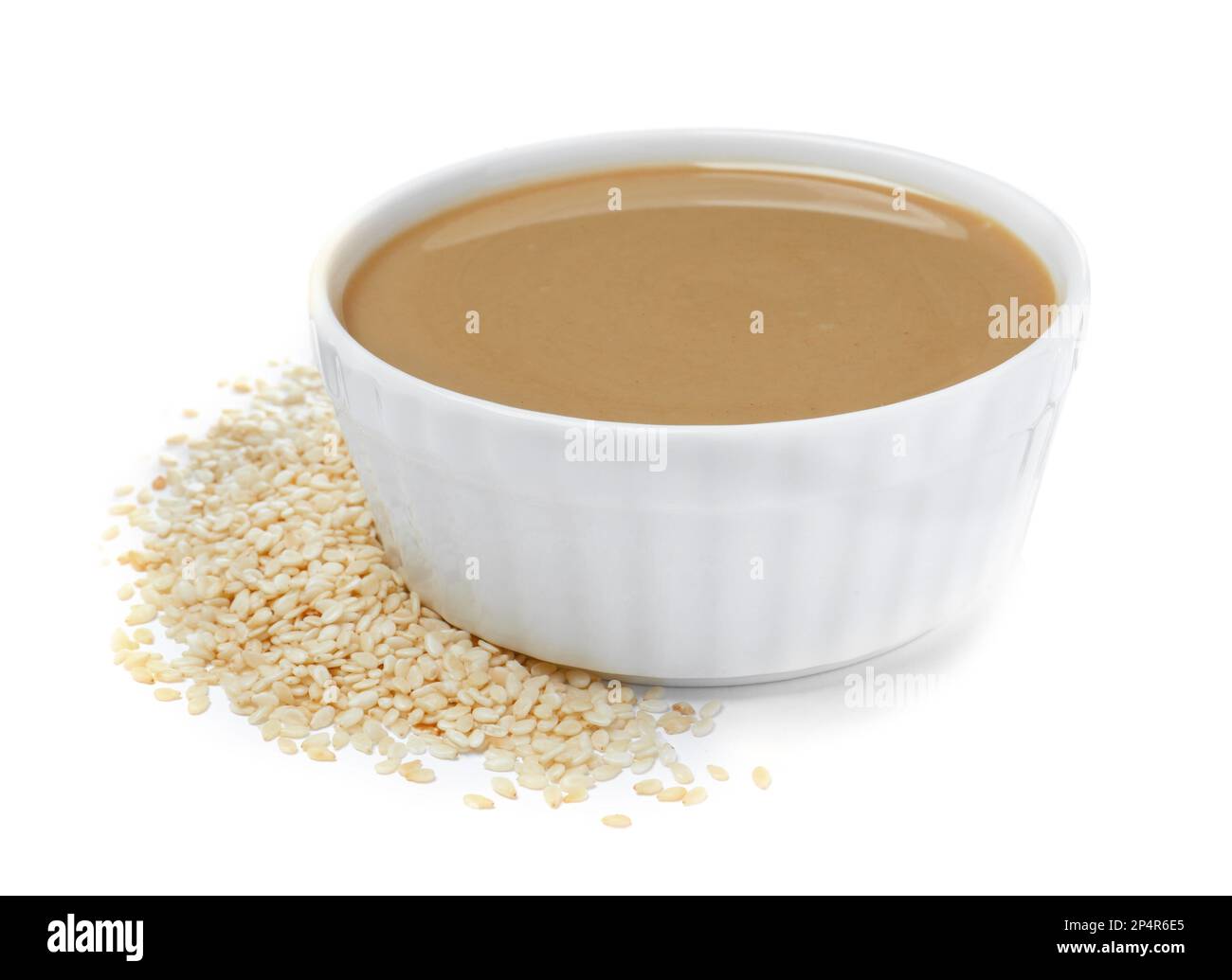 Tasty sesame paste in bowl and seeds on white background Stock Photo ...
