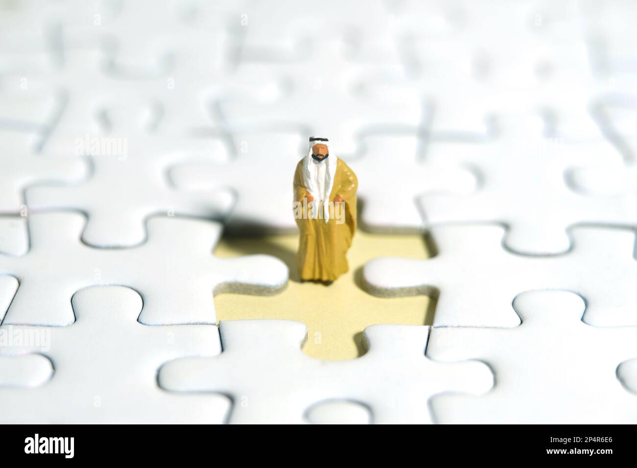 Miniature people toy figure photography. A Sultan wearing yellow Bisht ...