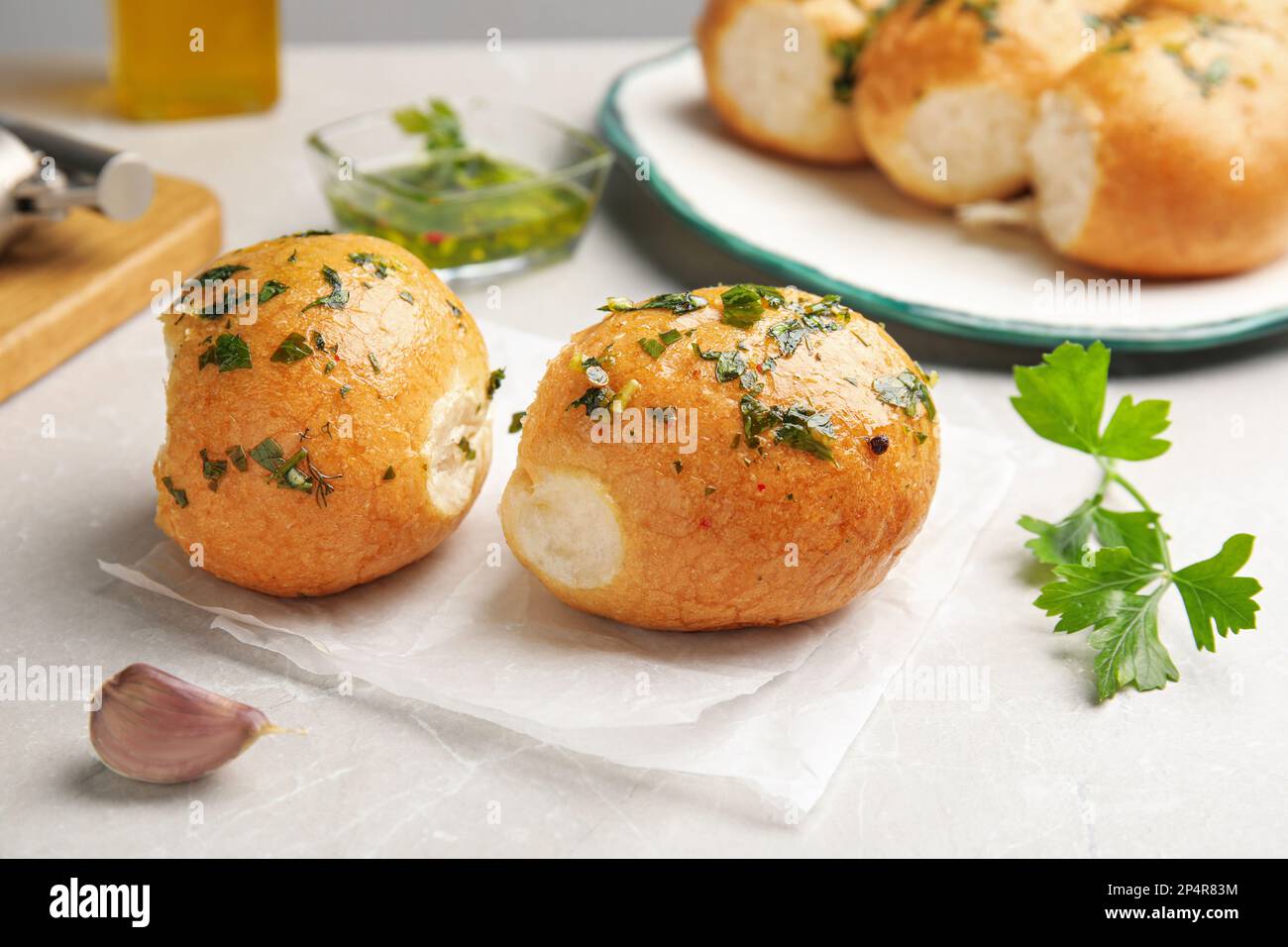 Traditional Ukrainian bread (Pampushky) with garlic on light table ...
