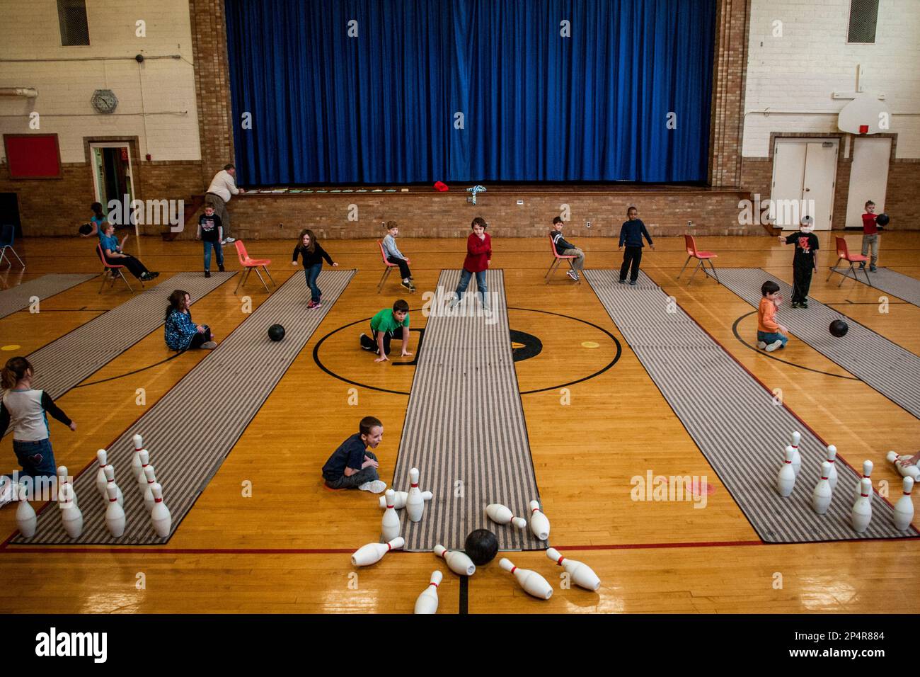 Second-graders practice bowling techniques during physical education ...